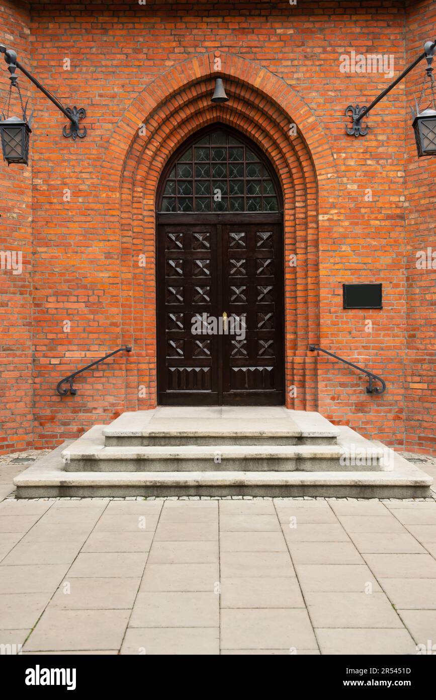 Entrance of building with beautiful arched wooden door Stock Photo - Alamy