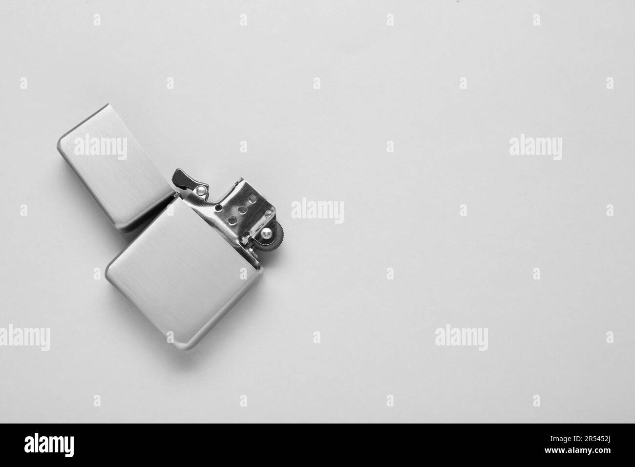 Gray metallic cigarette lighter on white background, top view. Space ...