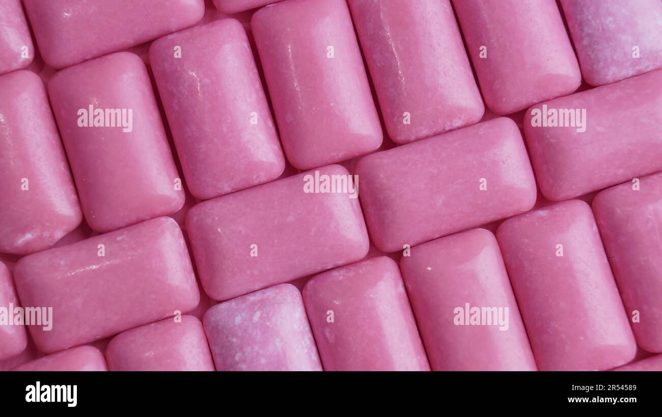Many pink chewing gums as background, top view Stock Photo - Alamy