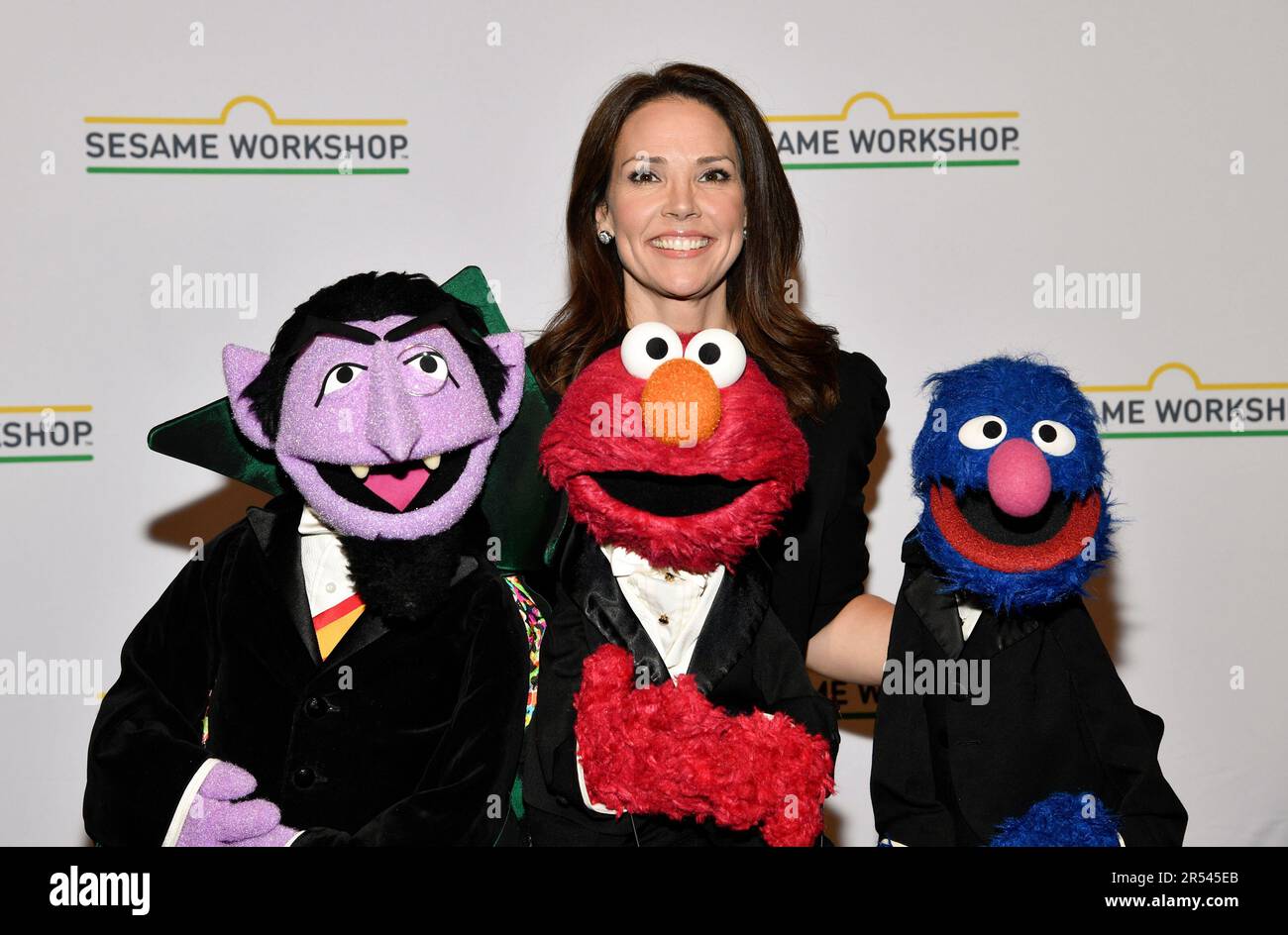 CNN anchor Erica Hill, center, poses with Count von Count, Elmo and ...