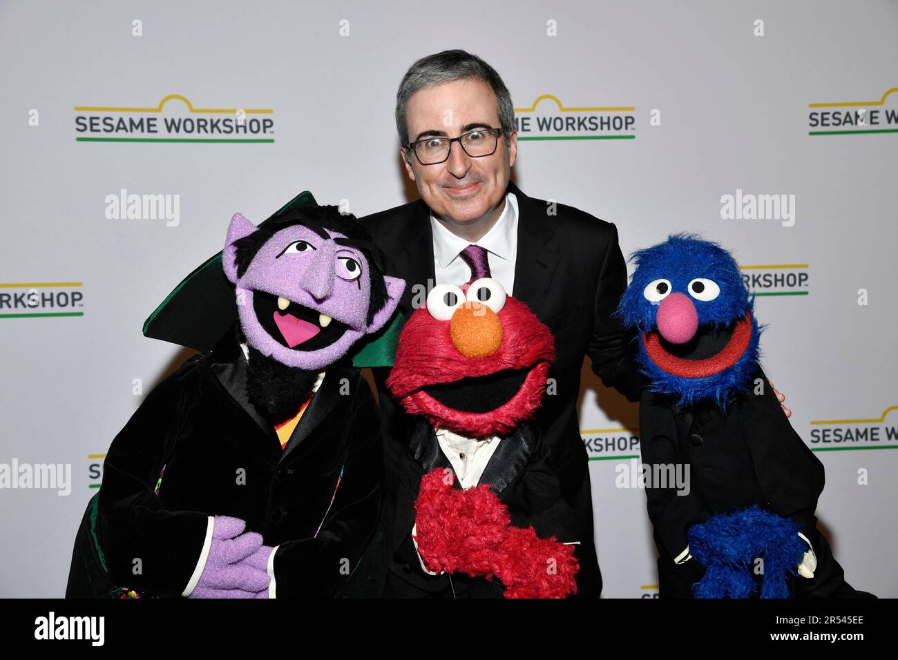 Television host John Oliver, center, poses with Count von Count, Elmo ...