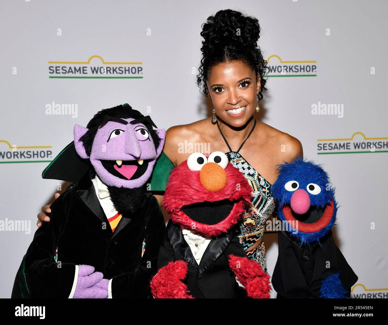 Actor Renée Elise Goldsberry, center, poses with Count von Count, Elmo ...
