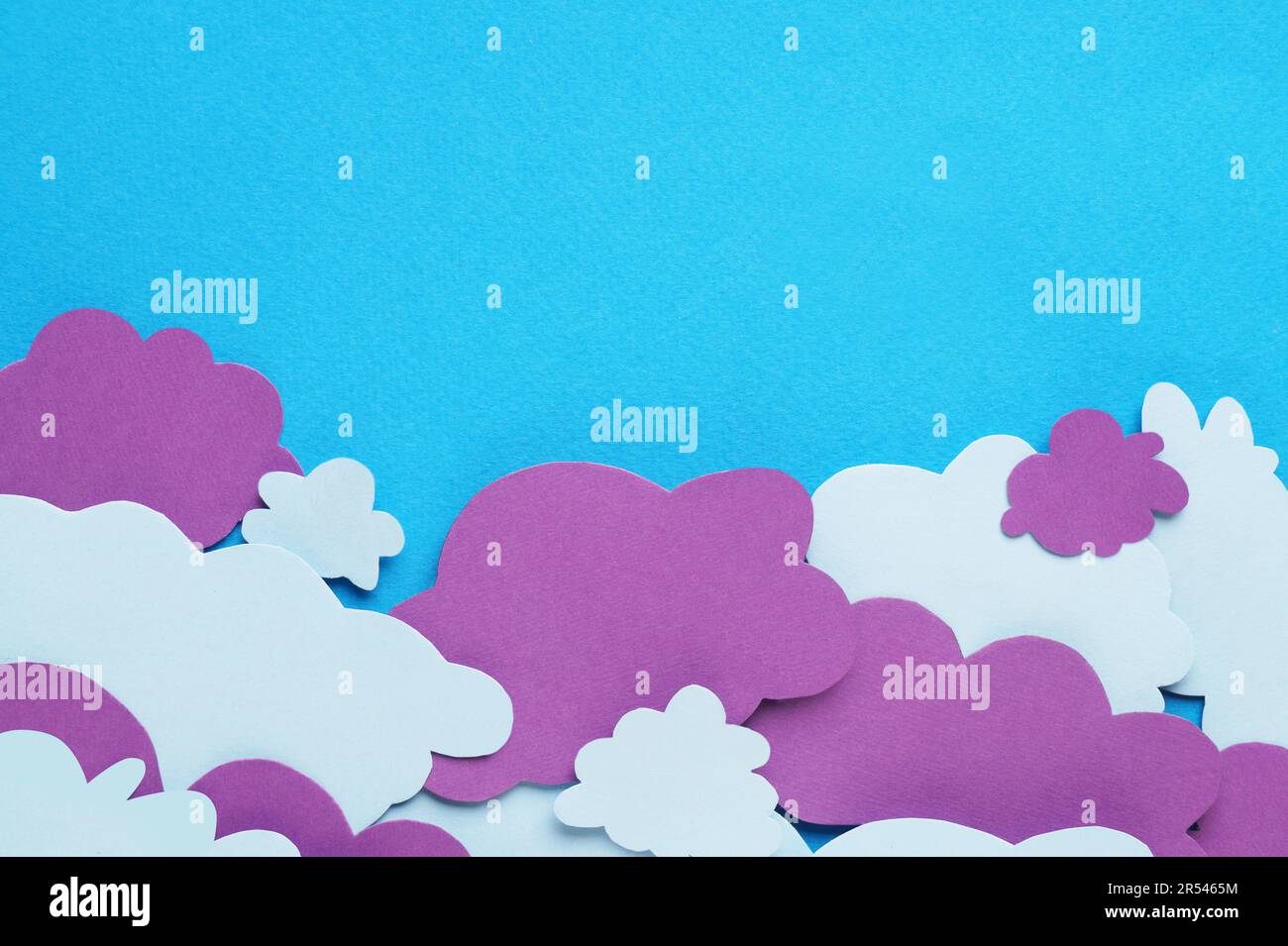 Paper speech bubbles in shape of clouds on light blue background, flat ...