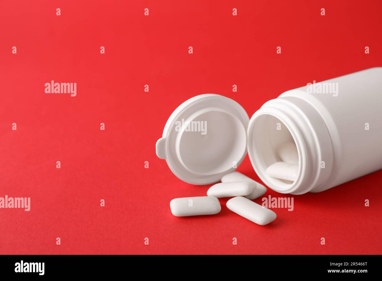 Jar with chewing gums on red background Stock Photo - Alamy