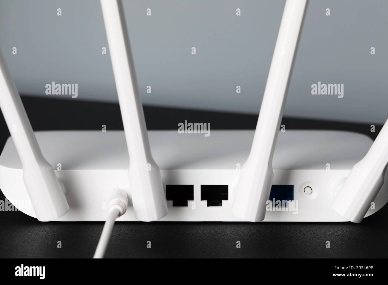 New white Wi-Fi router on black table, back view Stock Photo - Alamy