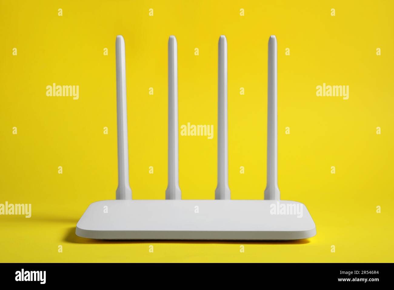 New white Wi-Fi router on yellow background Stock Photo - Alamy