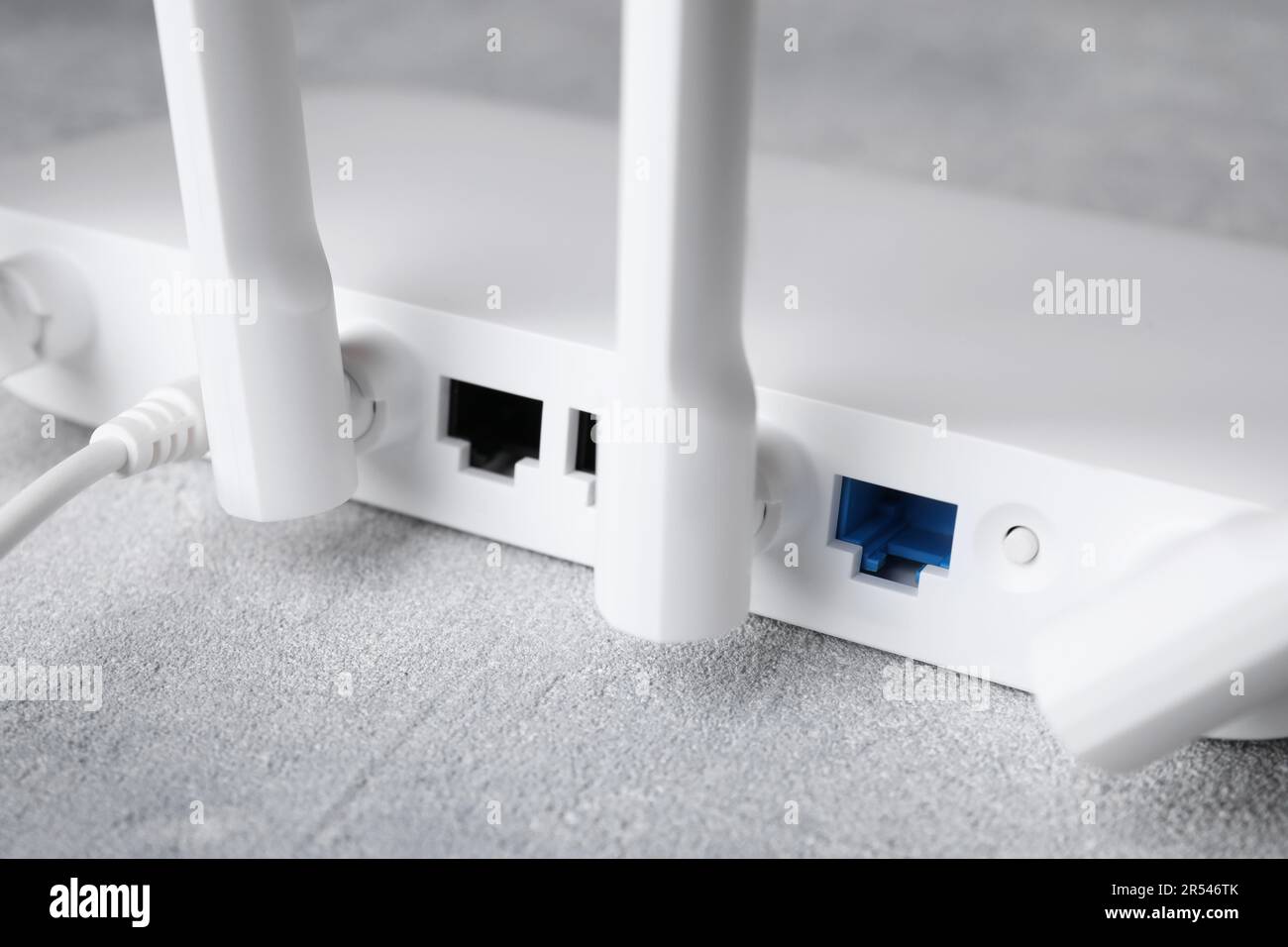 New modern Wi-Fi router on grey table, closeup Stock Photo - Alamy