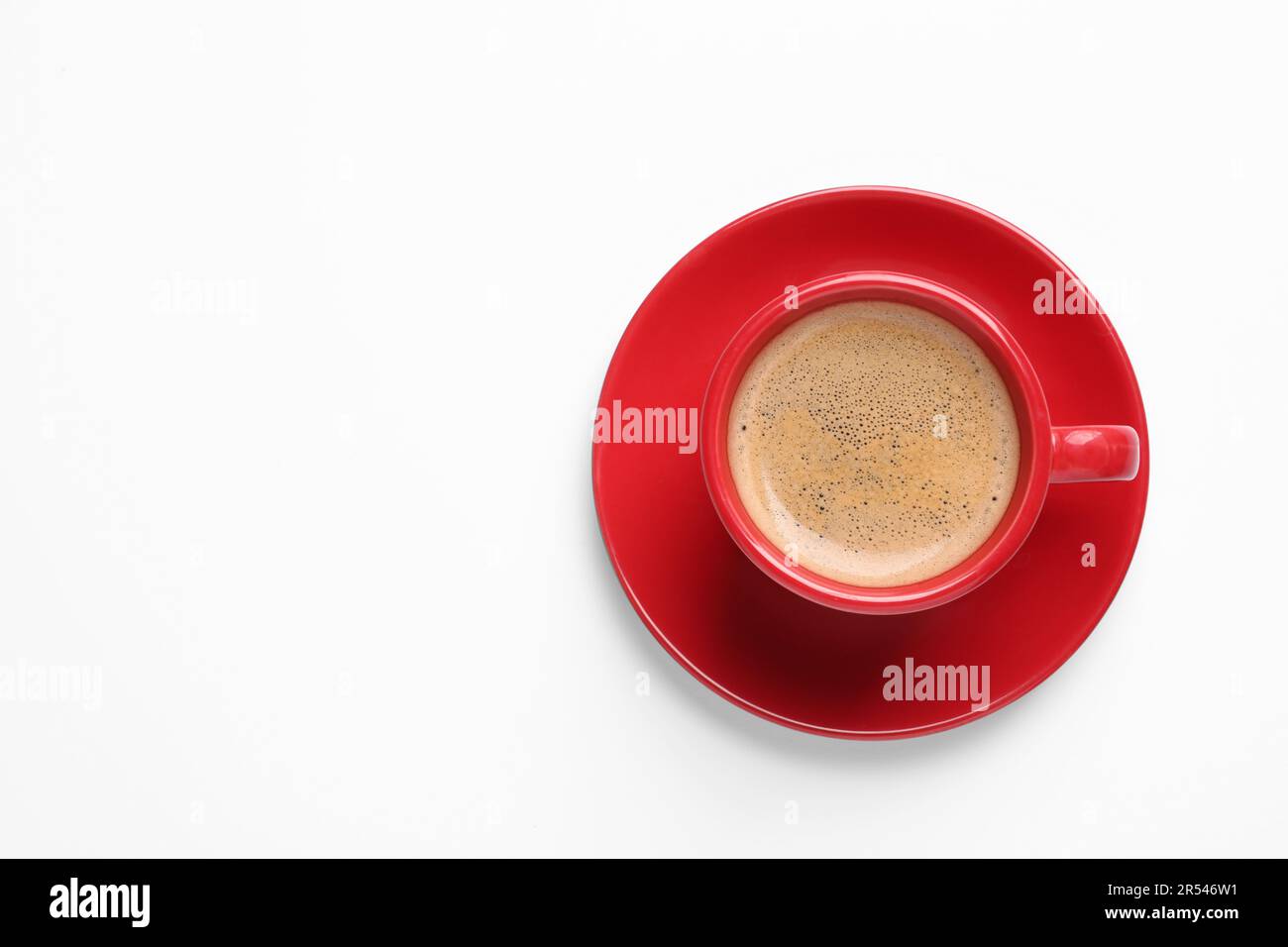 Red ceramic cup with hot aromatic coffee isolated on white, top view ...