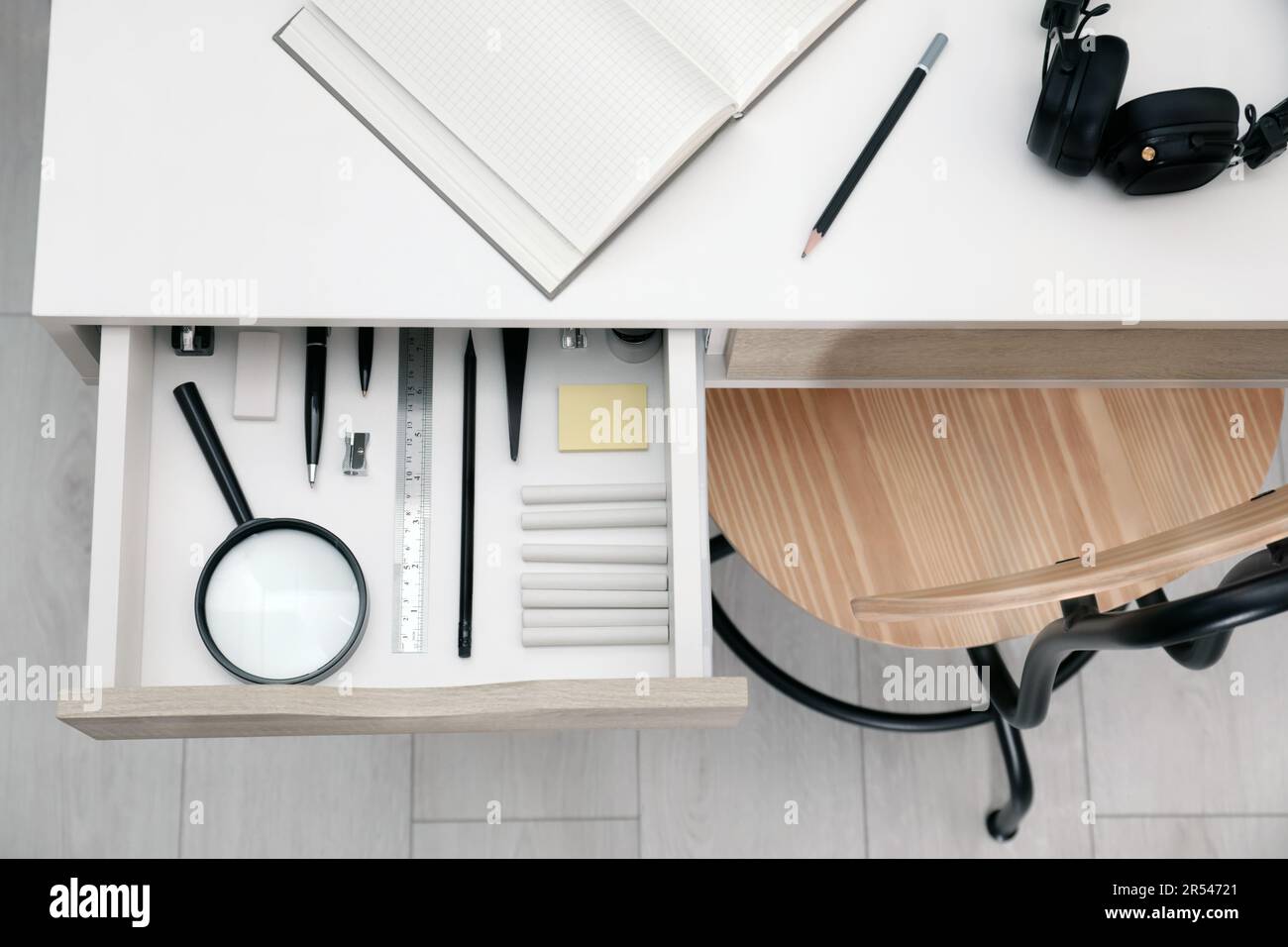 Office supplies in open desk drawer, top view Stock Photo - Alamy