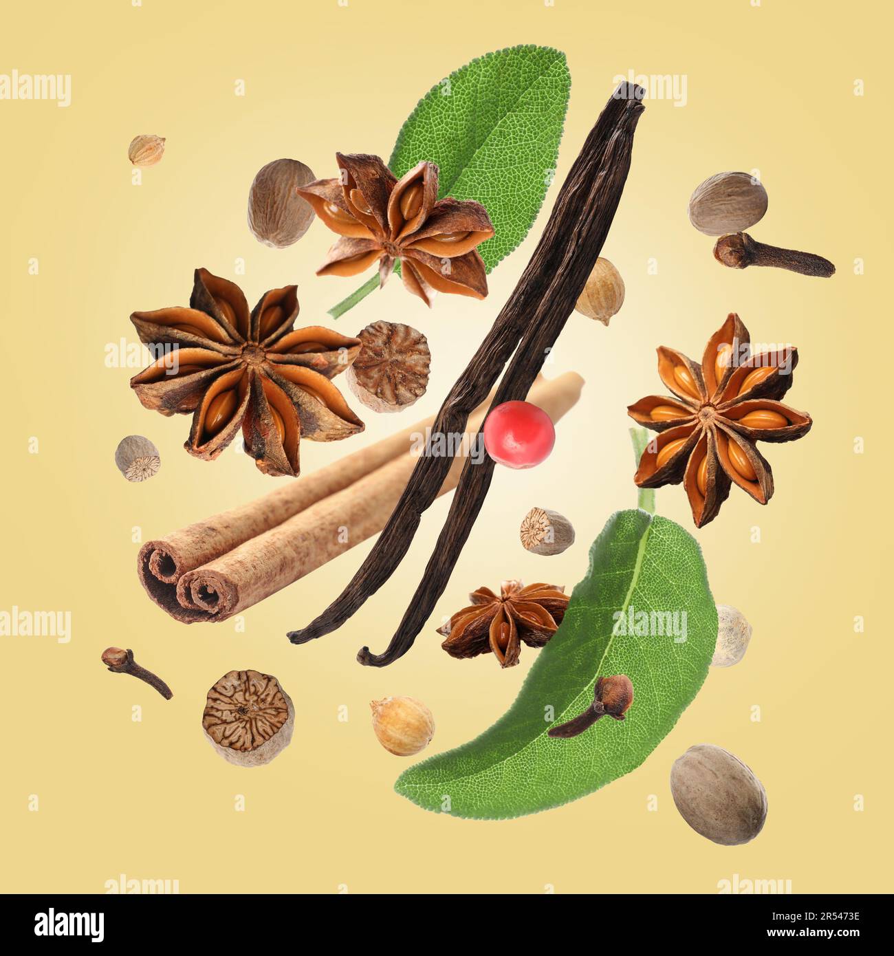 Many different spices falling on pale yellow background Stock Photo - Alamy