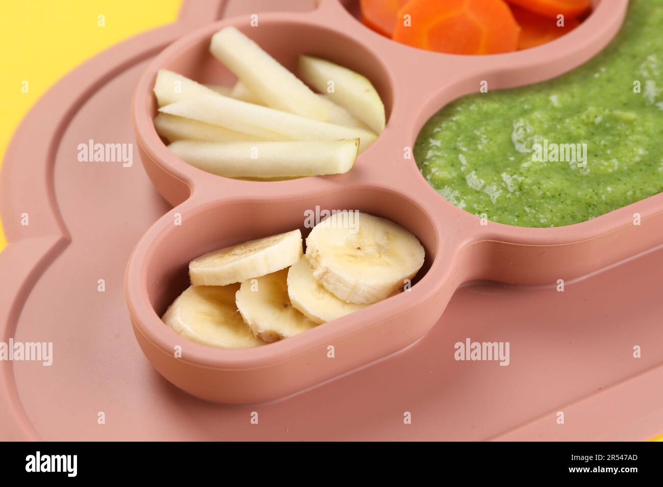 Healthy baby food. Section plate with delicious broccoli puree ...