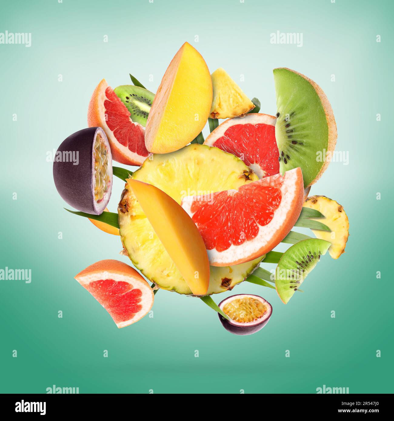 Many fresh tropical fruits falling on turquoise background Stock Photo ...