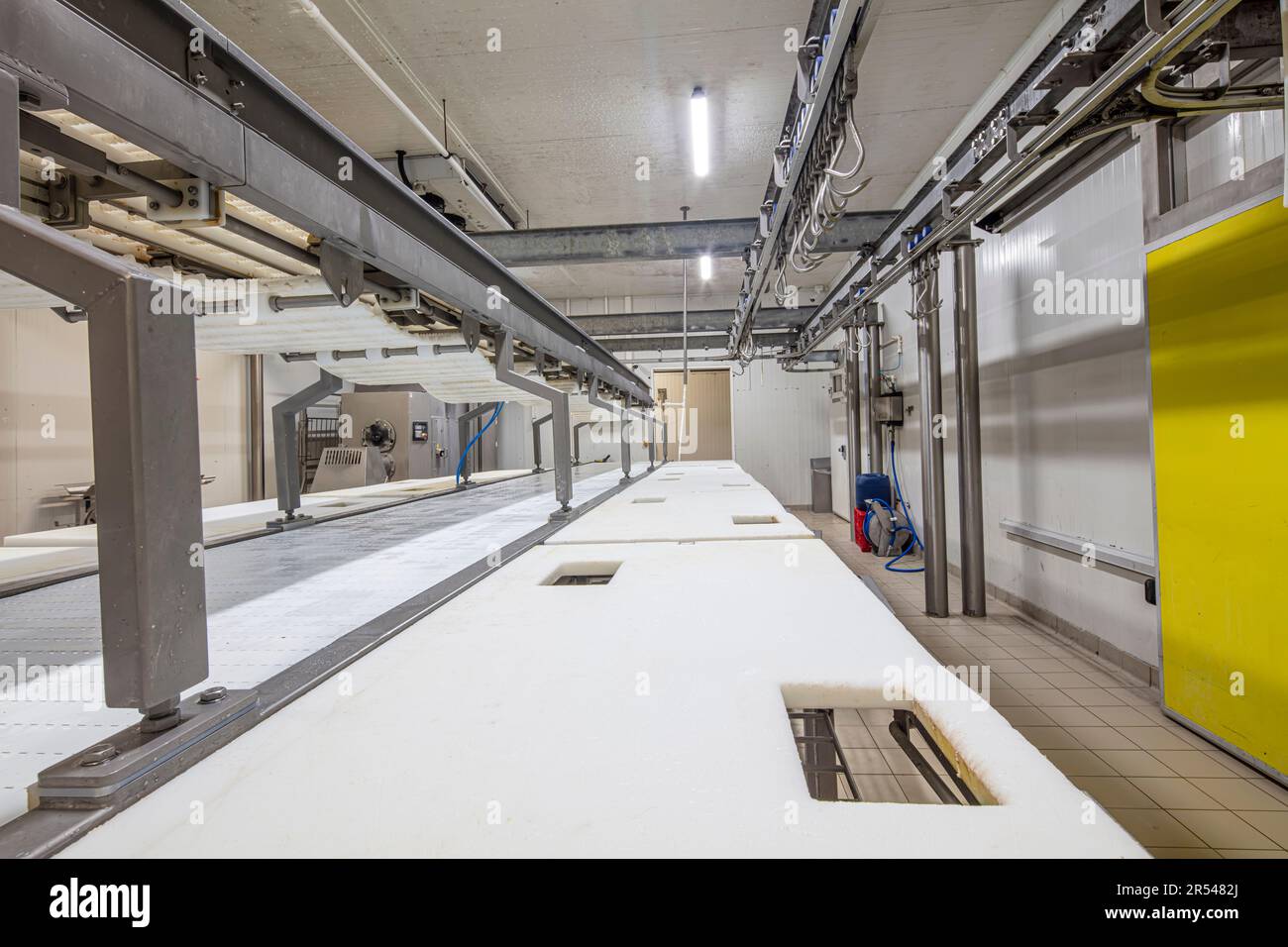Meat processing machines at meat factory. Cutting meat in ...