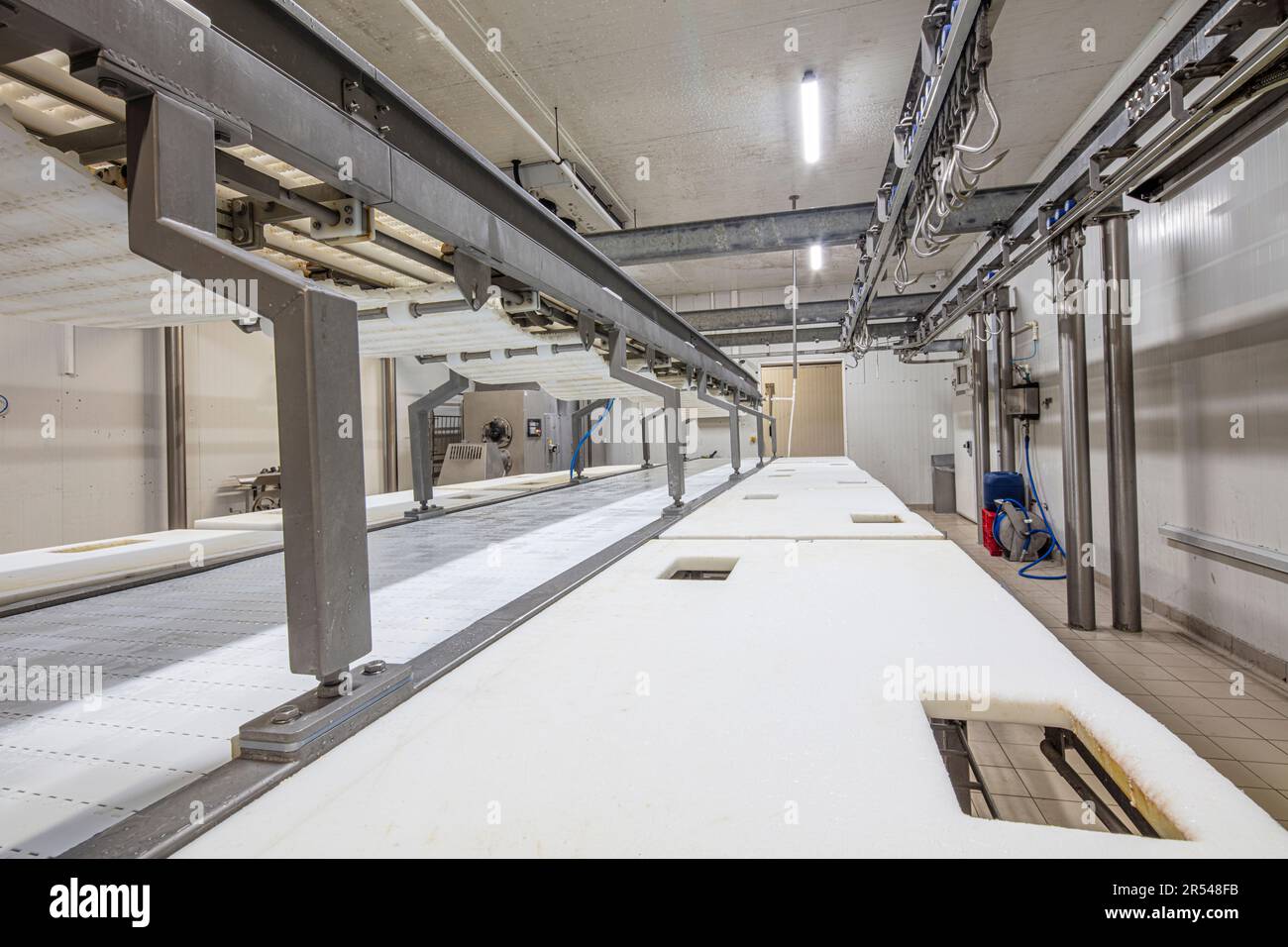 Meat processing machines at meat factory. Cutting meat in ...