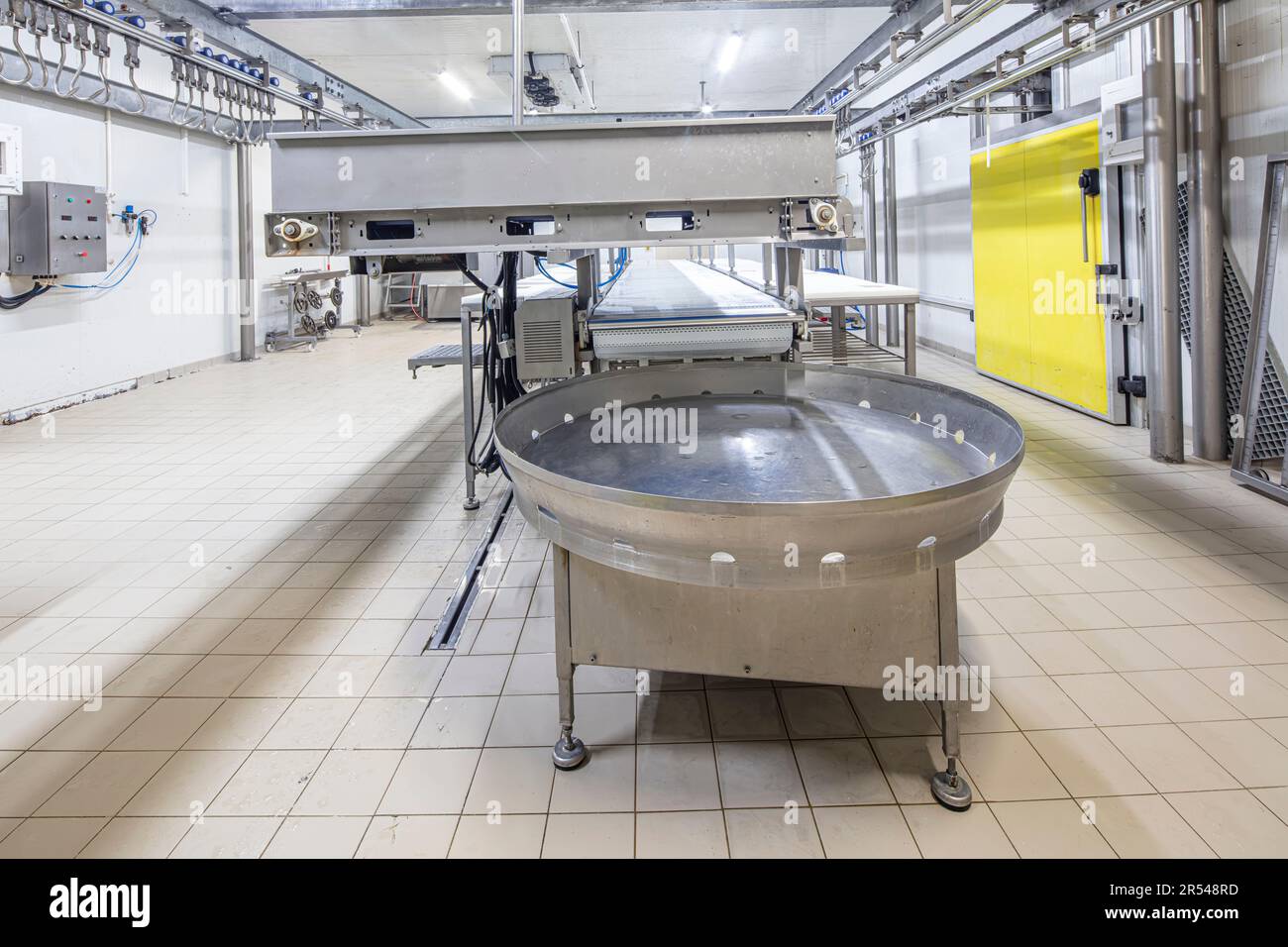 Meat processing machines at meat factory. Cutting meat in ...