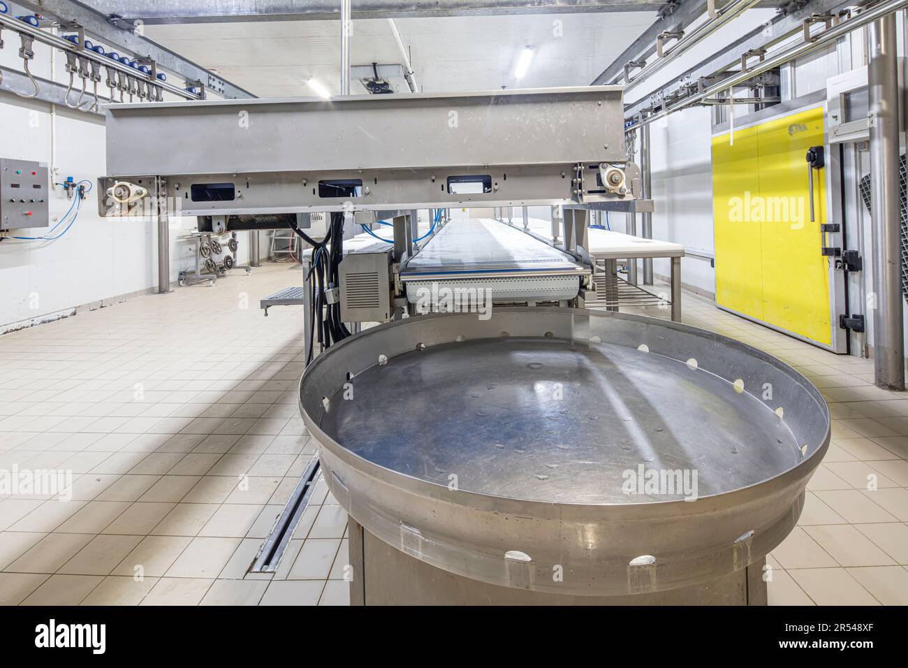 Meat processing machines at meat factory. Cutting meat in ...