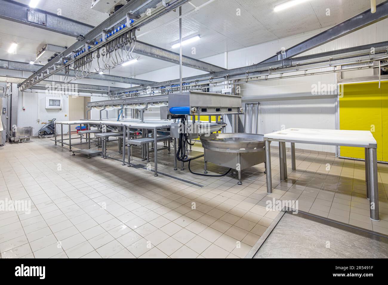 Meat processing machines at meat factory. Cutting meat in ...