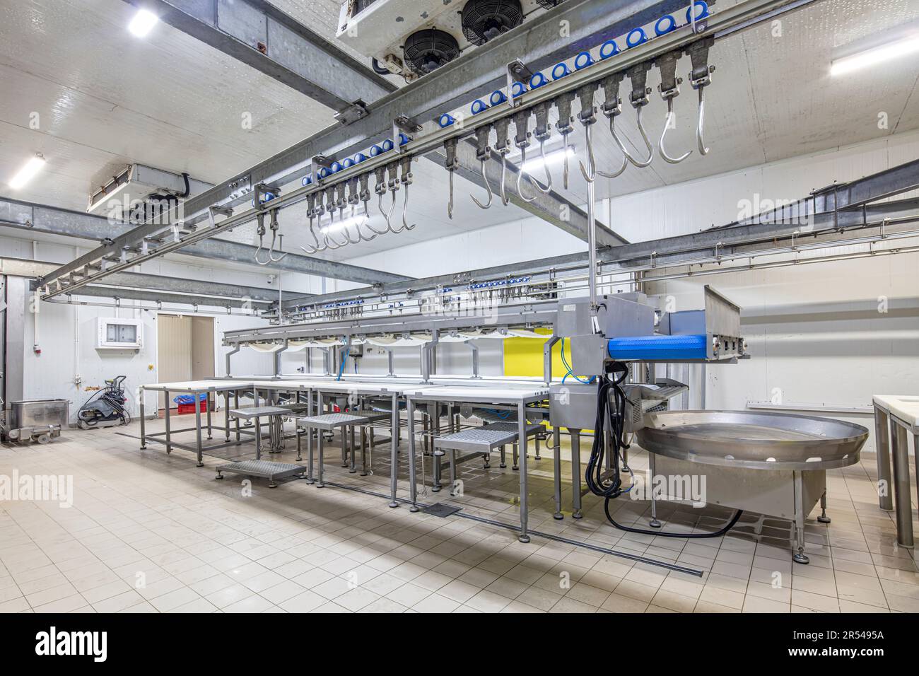 Meat processing machines at meat factory. Cutting meat in ...