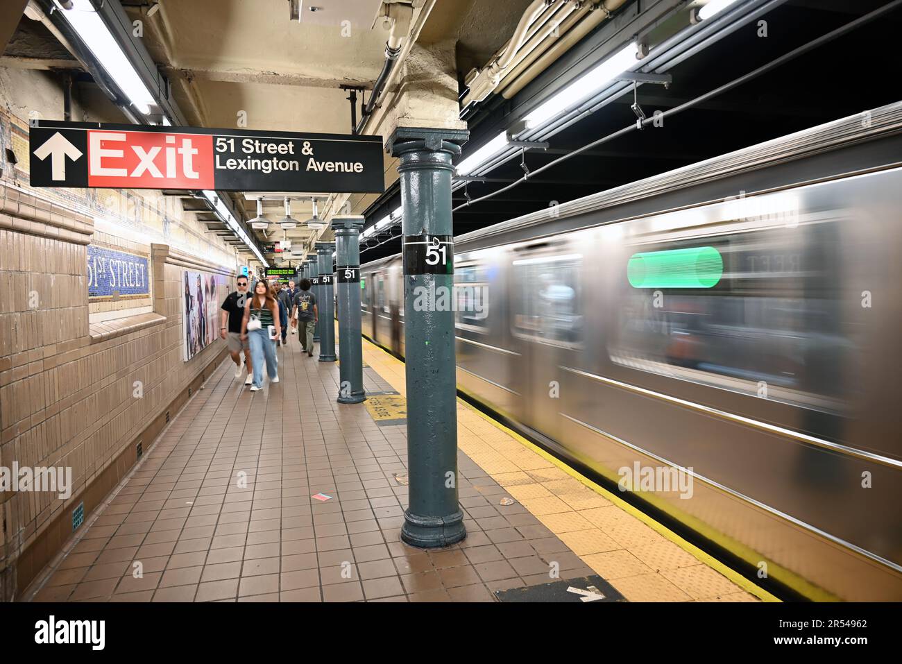 A MTA subway train blurs as it leaves the 51st Street station in New ...