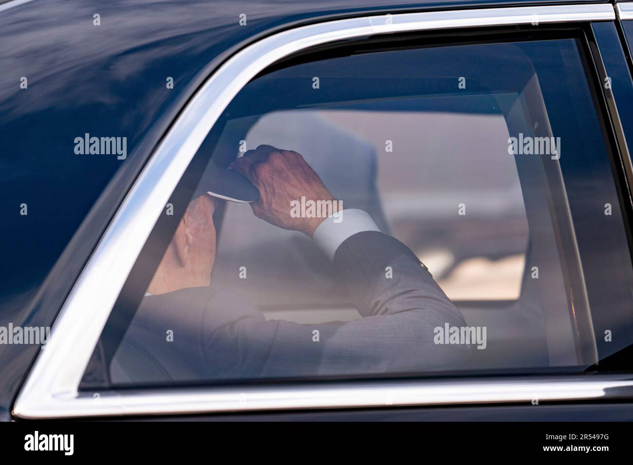 President Joe Biden sits in a presidential limousine known as "The ...