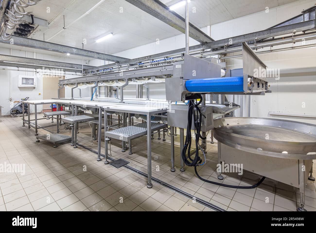 Meat processing machines at meat factory. Cutting meat in ...