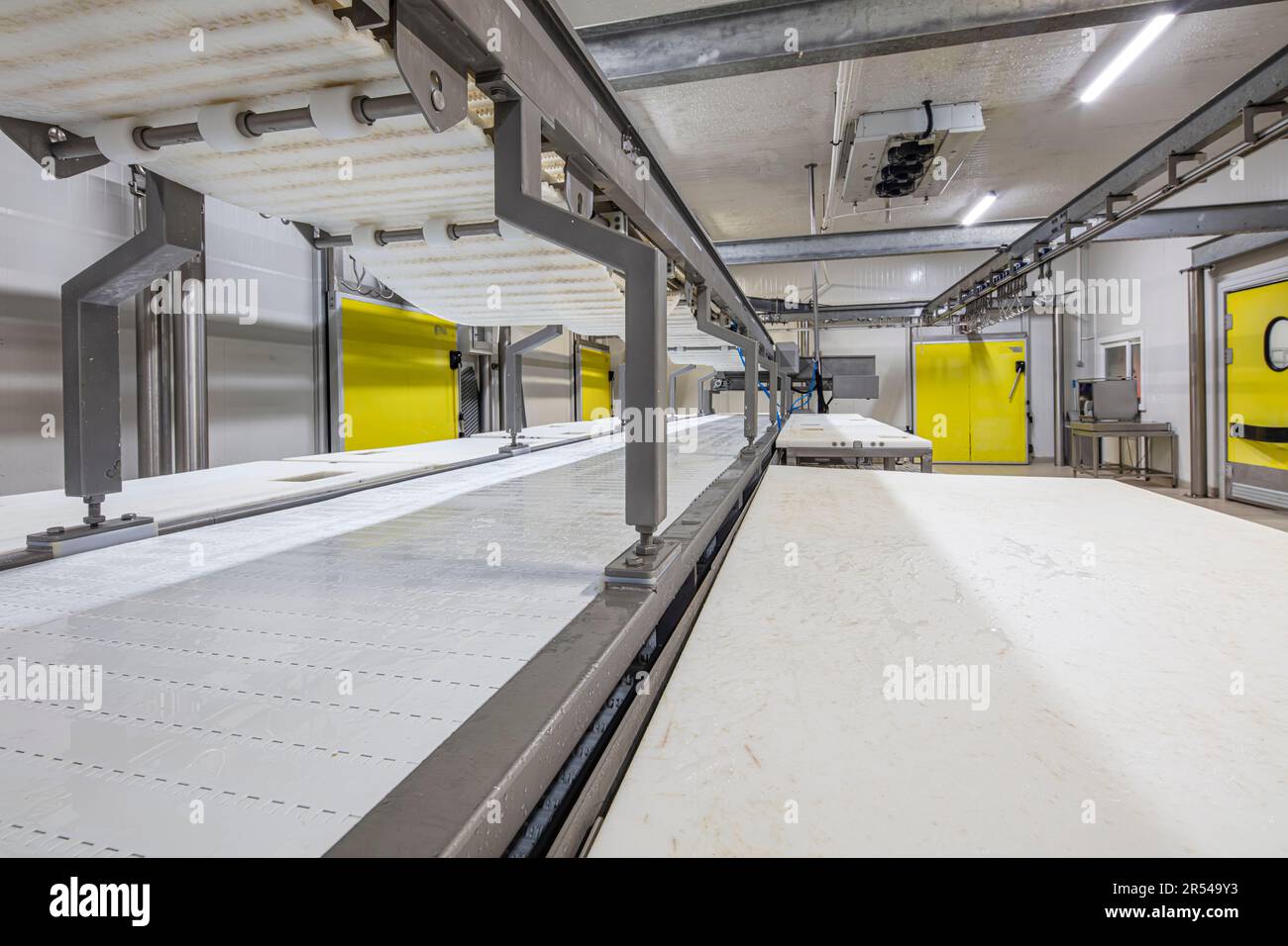 Meat processing machines at meat factory. Cutting meat in ...