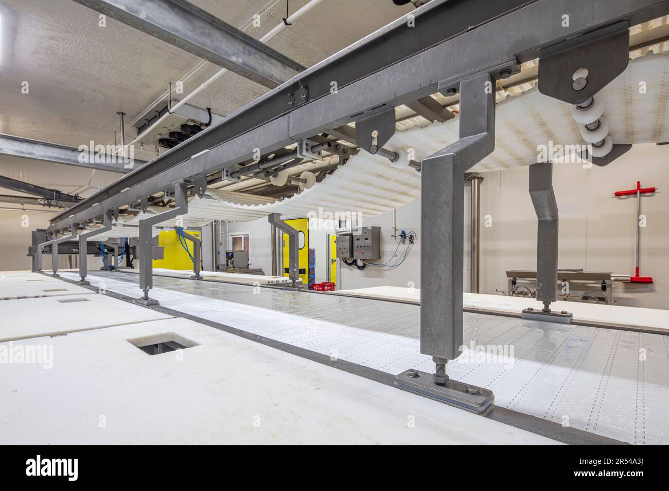 Meat processing machines at meat factory. Cutting meat in ...