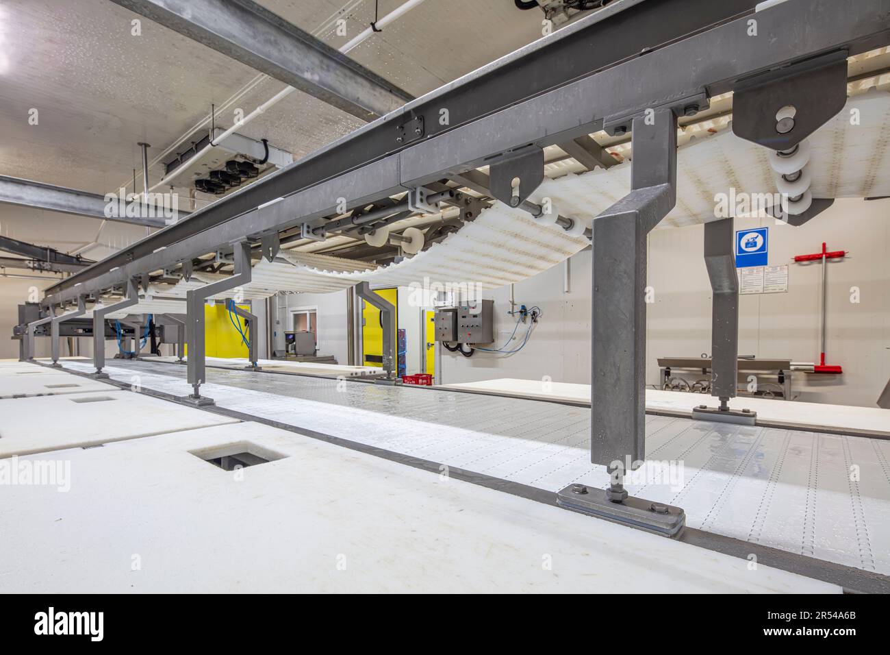 Meat processing machines at meat factory. Cutting meat in ...