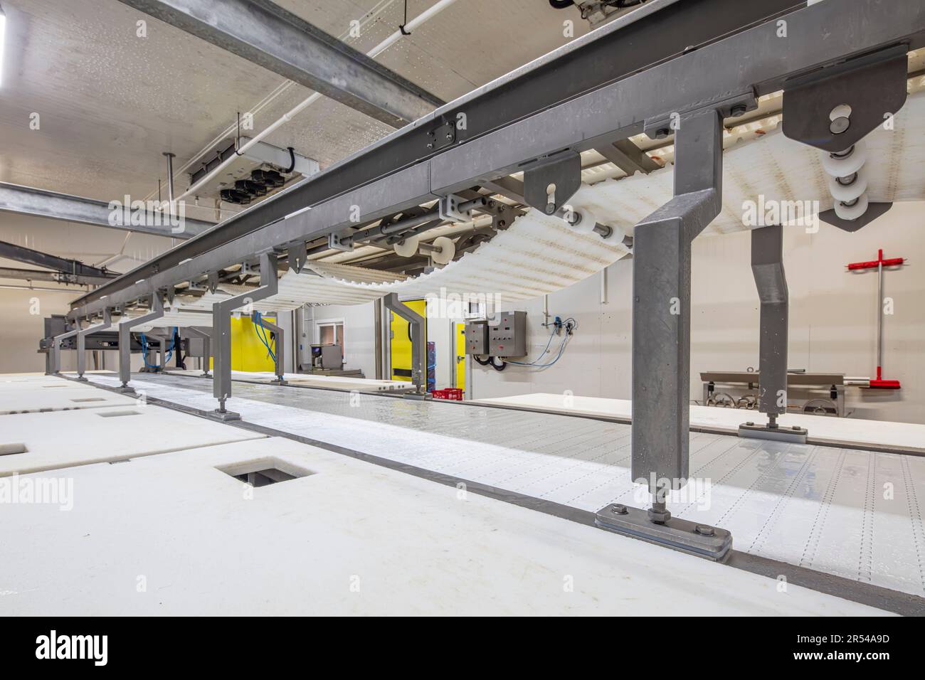 Meat processing machines at meat factory. Cutting meat in ...