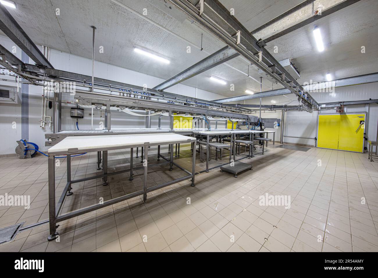 Meat processing machines at meat factory. Cutting meat in ...