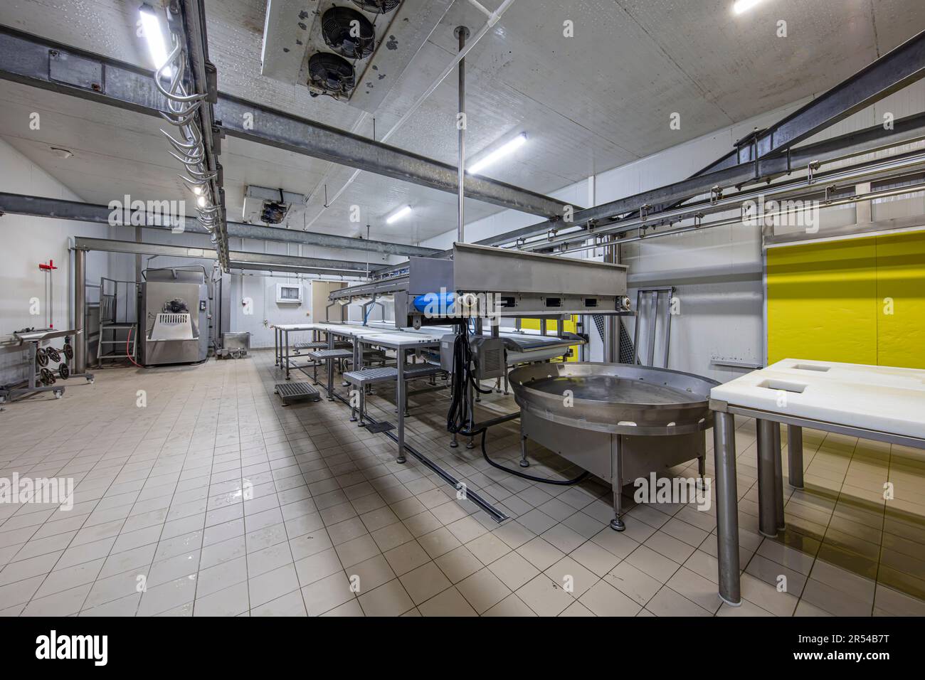 Meat processing machines at meat factory. Cutting meat in ...