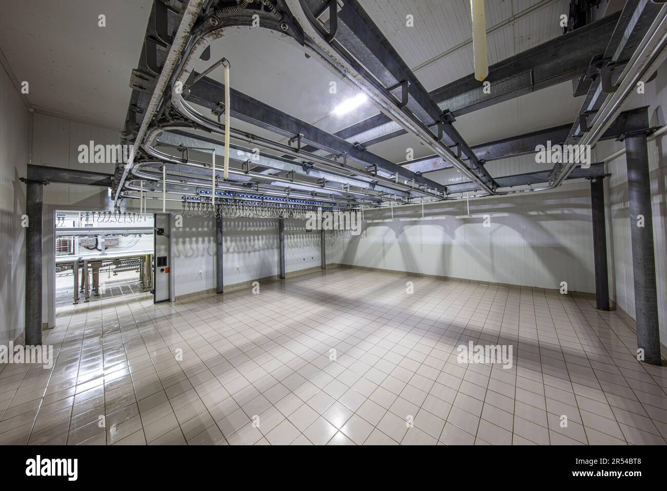 Meat processing machines at meat factory. Cutting meat in ...