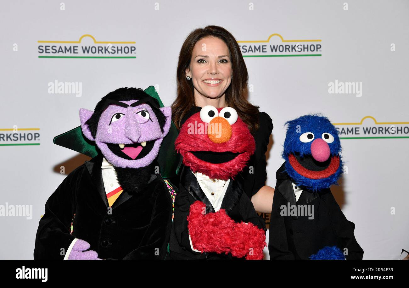 CNN anchor Erica Hill, center, poses with Count von Count, Elmo and Grover at the Sesame ...