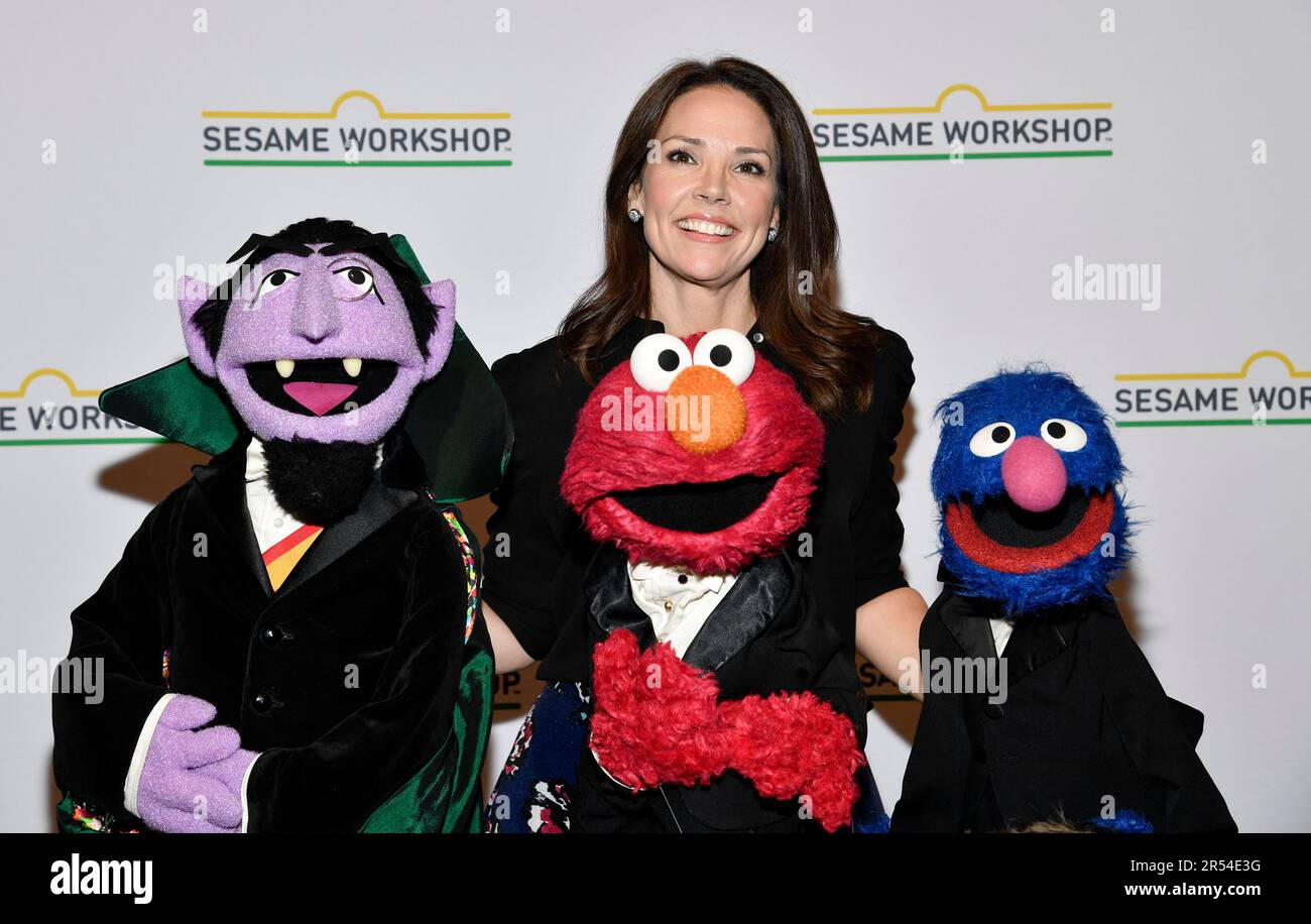 CNN anchor Erica Hill, center, poses with Count von Count, Elmo and ...