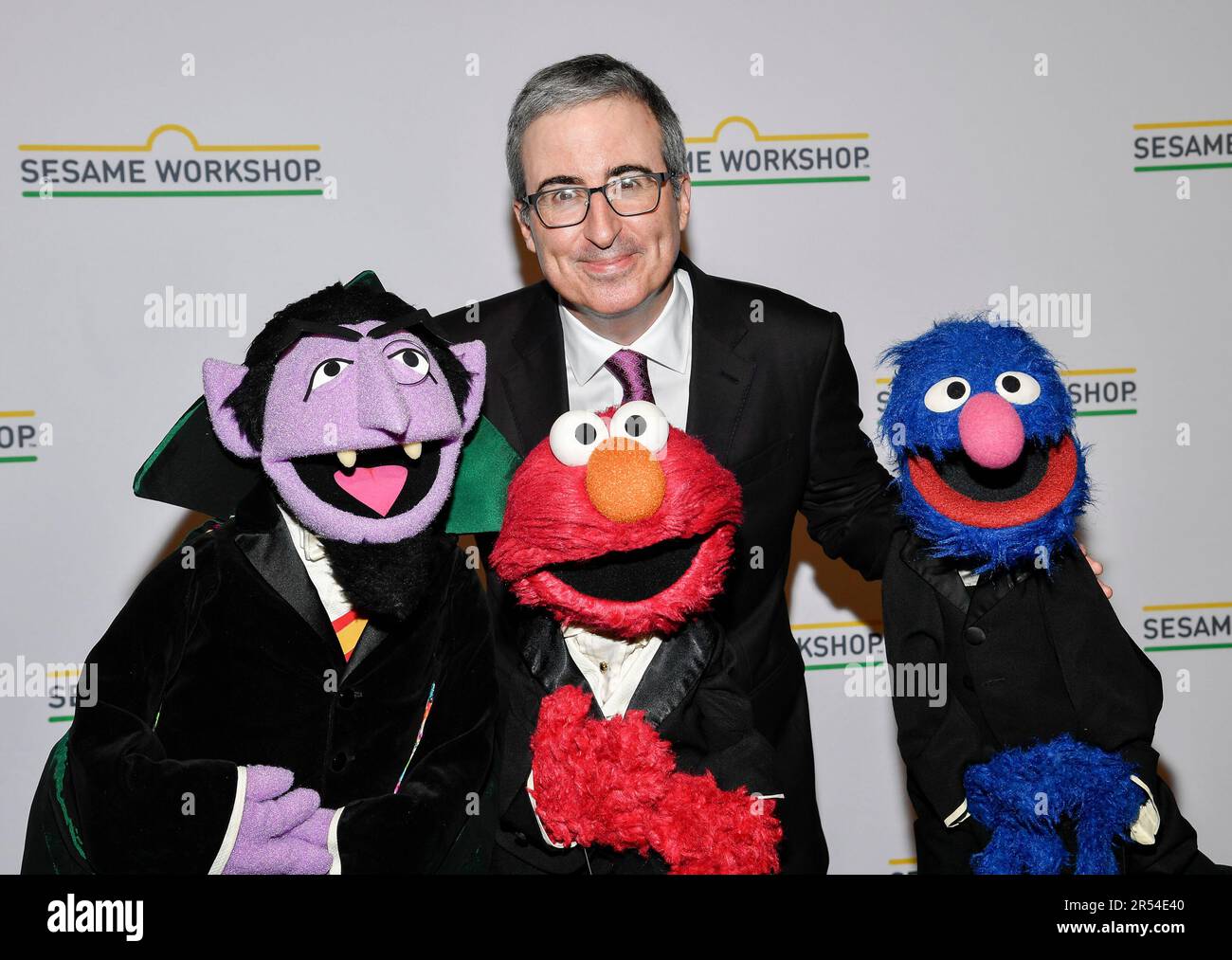Television host John Oliver, center, poses with Count von Count, Elmo ...