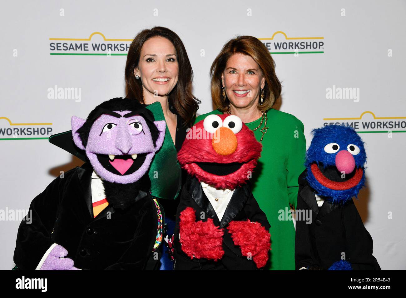 CNN anchor Erica Hill, left, and Sherrie Westin pose with Count von Count, Elmo and Grover at ...