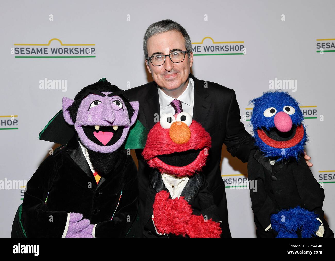 Television host John Oliver, center, poses with Count von Count, Elmo ...