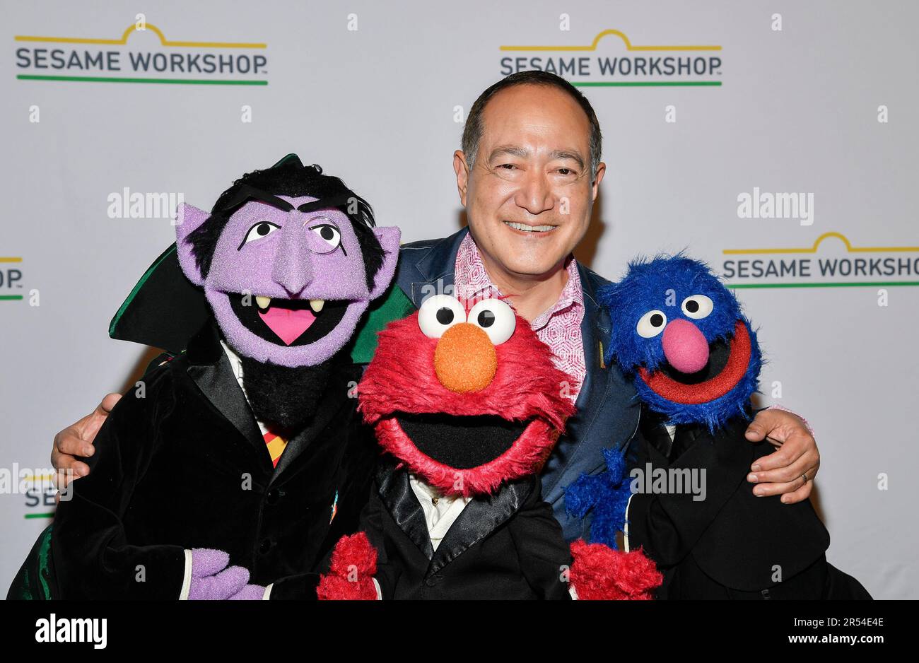 Actor Alan Muraoka, center, poses with Count von Count, Elmo and Grover ...