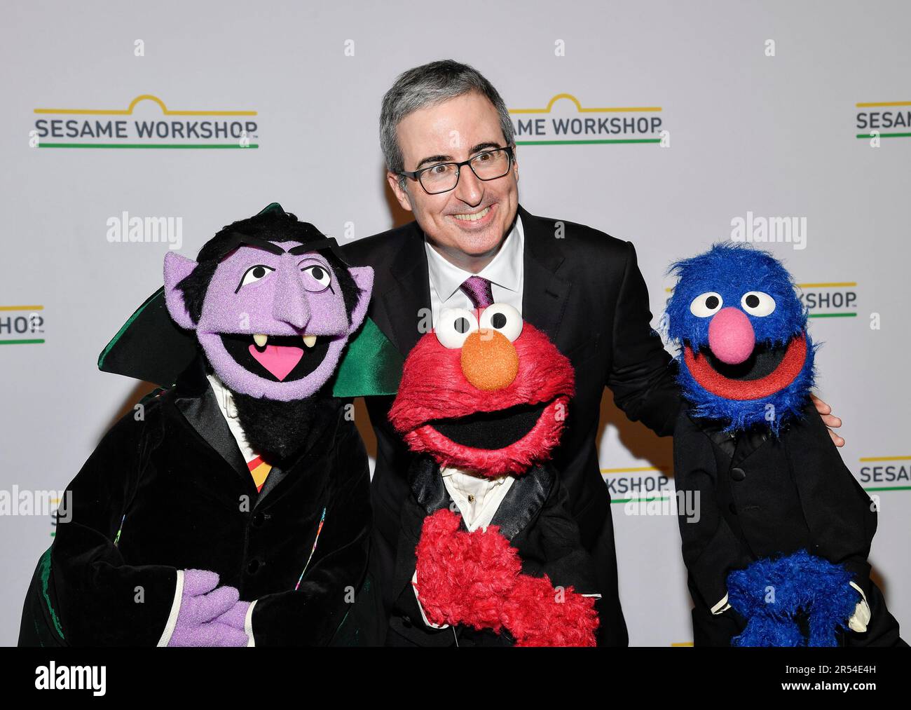 Television host John Oliver, center, poses with Count von Count, Elmo and Grover at the Sesame ...