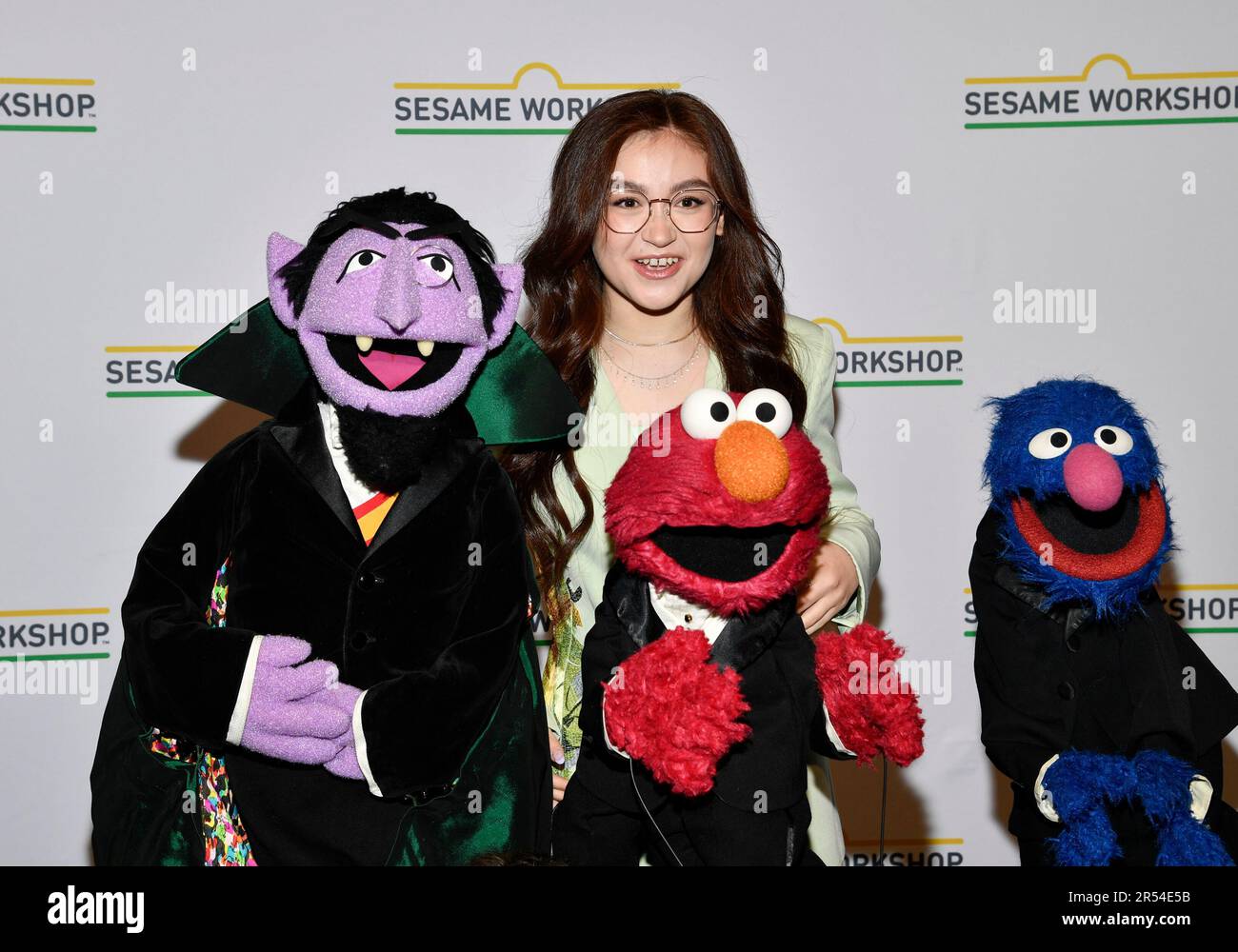Anna Cathcart, center, poses with Count von Count, Elmo and Grover at the Sesame Workshop annual ...
