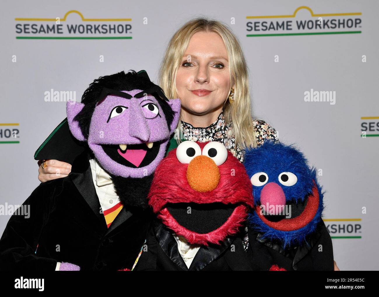 Laura Brown, center, poses with Count von Count, Elmo and Grover at the ...