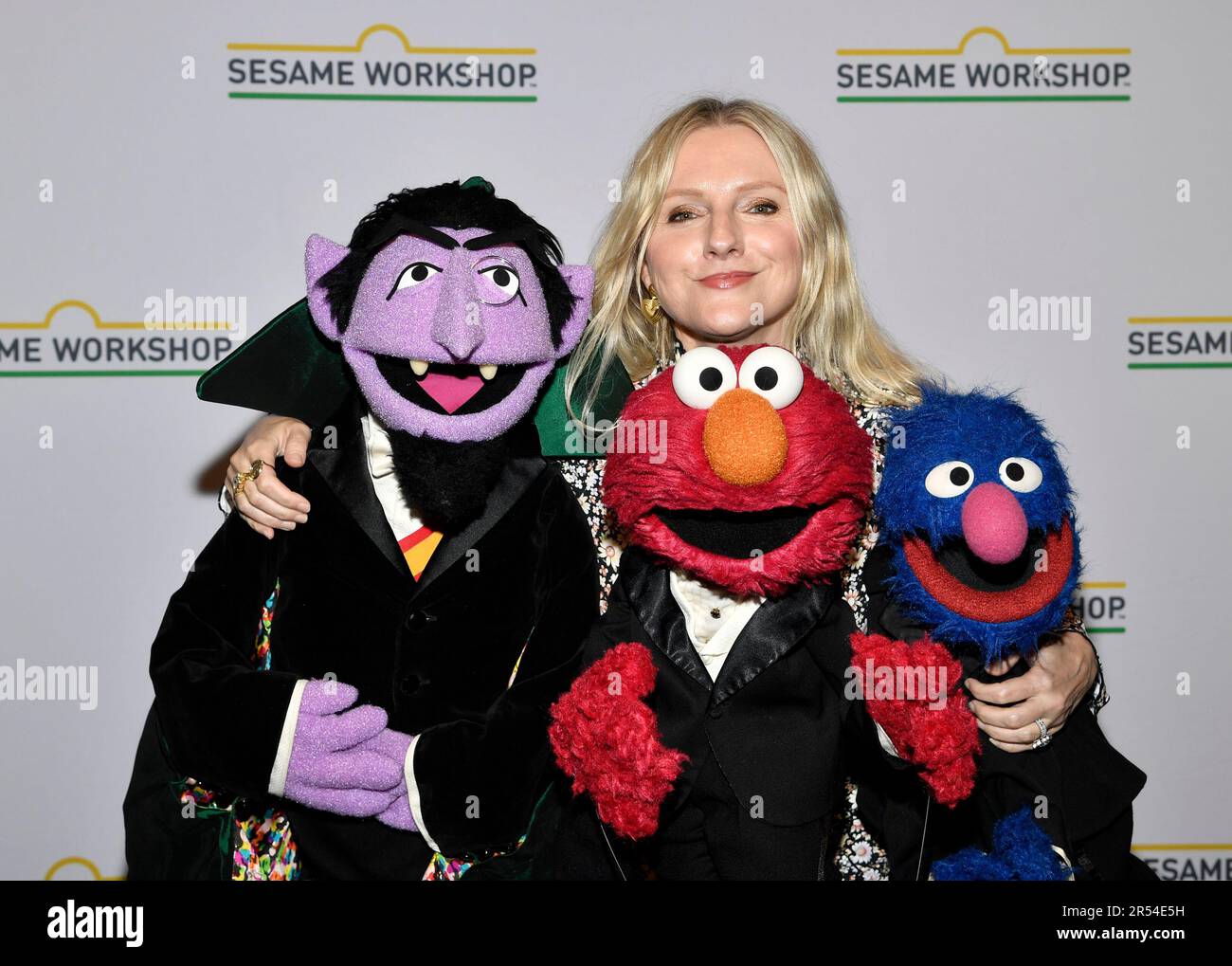Laura Brown, center, poses with Count von Count, Elmo and Grover at the ...