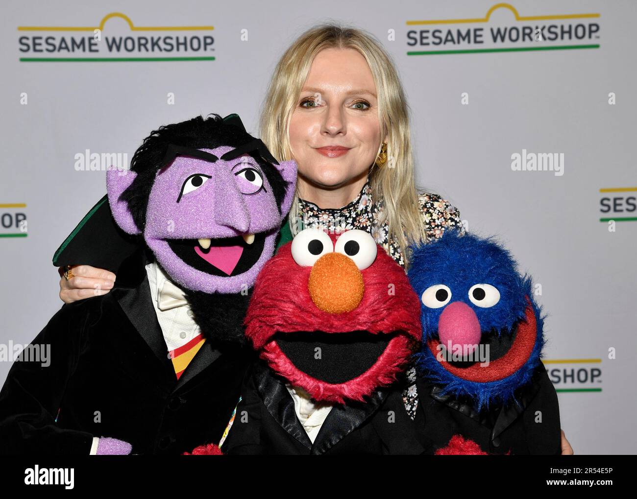 Laura Brown, center, poses with Count von Count, Elmo and Grover at the ...