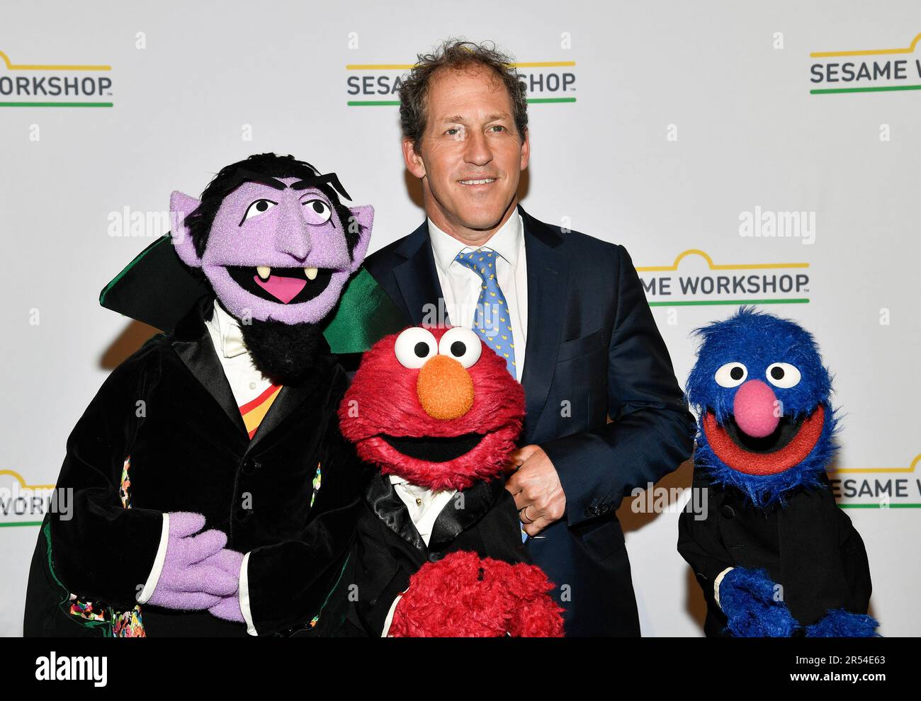Sesame Workshop CEO Steve Youngwood poses with Count von Count, Elmo and Grover at the Sesame ...