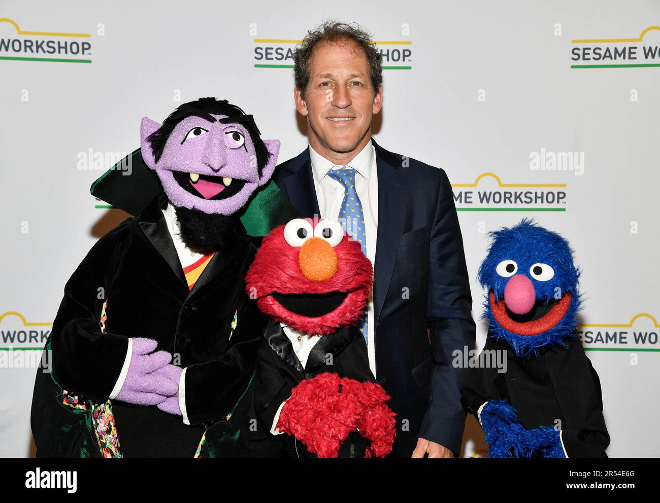 Sesame Workshop CEO Steve Youngwood poses with Count von Count, Elmo and Grover at the Sesame ...