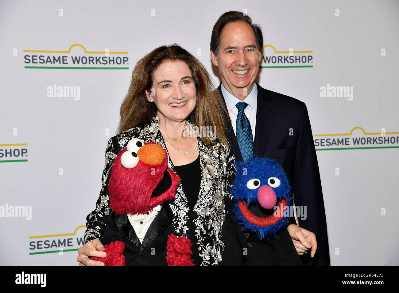 Cheryl Henson, left, and husband Edwin Finn Jr. pose with Sesame Street ...