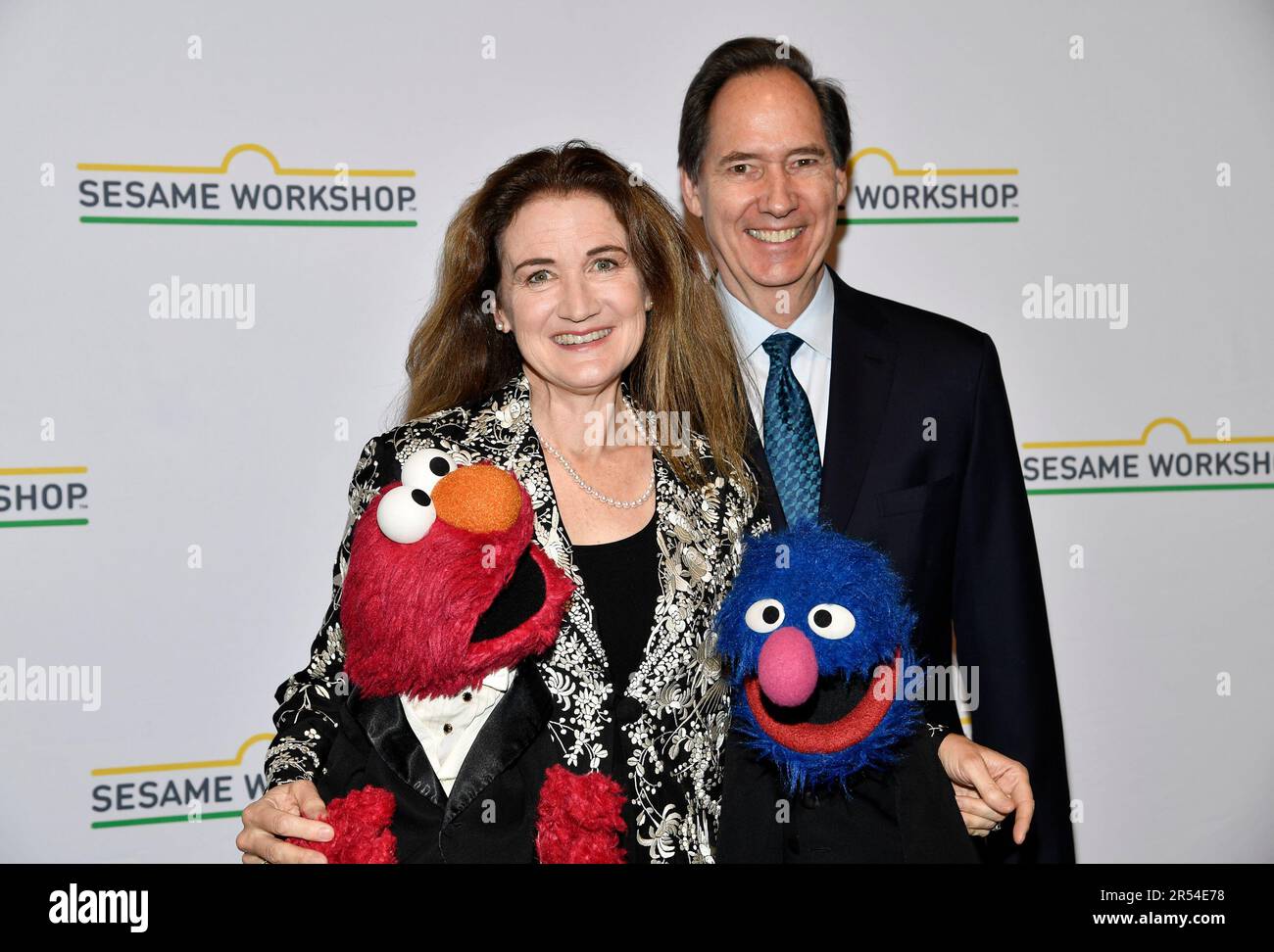 Cheryl Henson, left, and husband Edwin Finn Jr. pose with Sesame Street ...