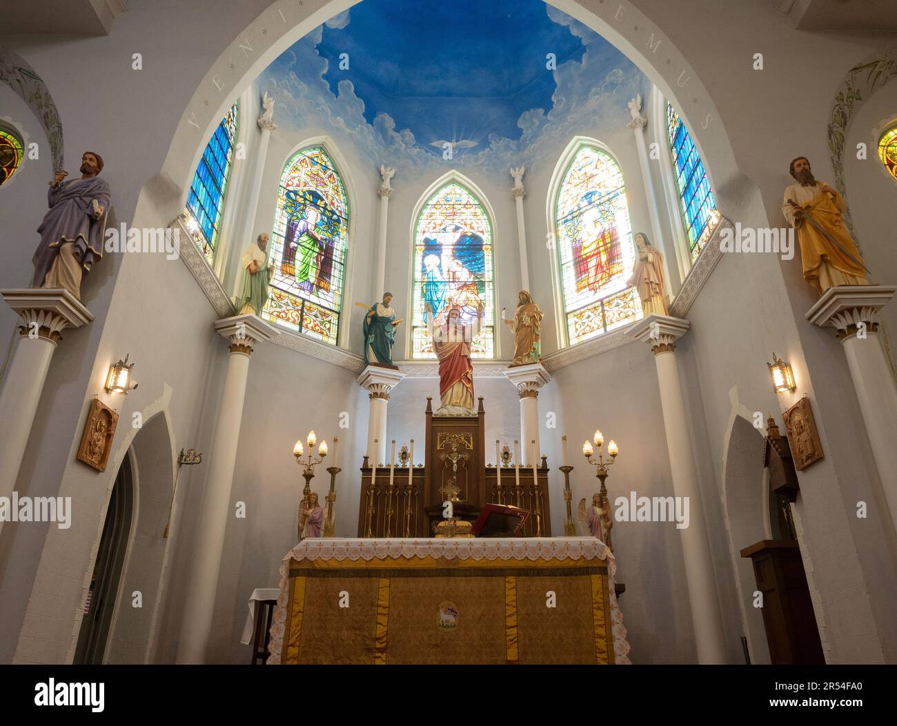 Altar, sanctuary, religious statues, and dome with stained glass ...