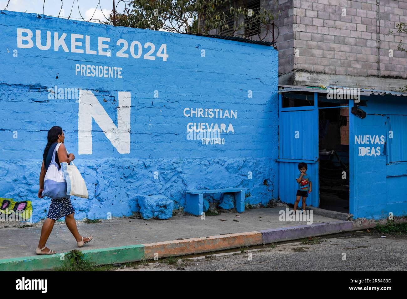A woman walks by a mural calling for the reelection of President Nayib ...