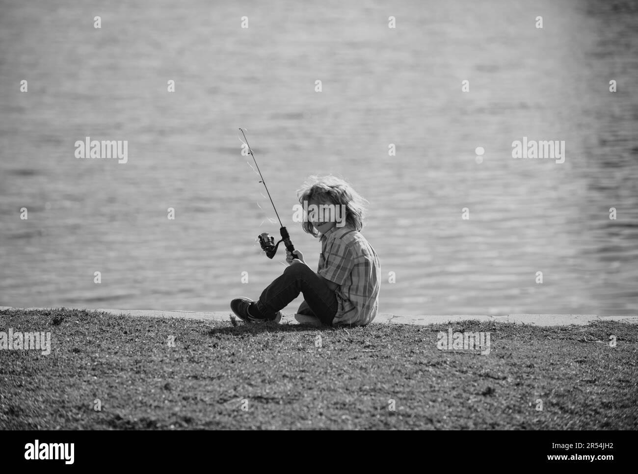 Kids hobby. Child fishing on the lake. Boy with spinner at river ...